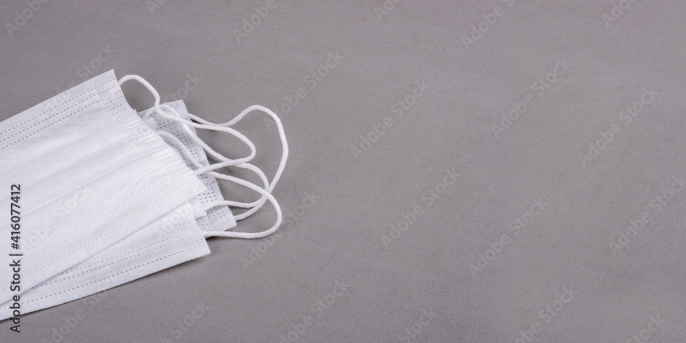 Coronavirus pandemic concept: On left frame many white medical facial ...