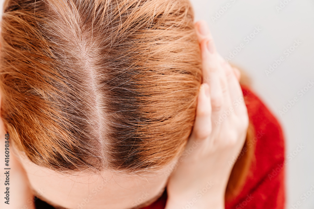 grown after staining the gray roots of hair on the head of a woman ...