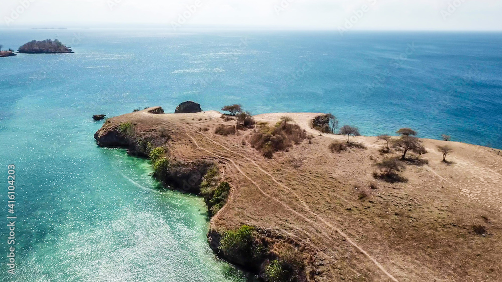 Beautiful headland formations on Lombok, Indonesia. Boats parked on the ...