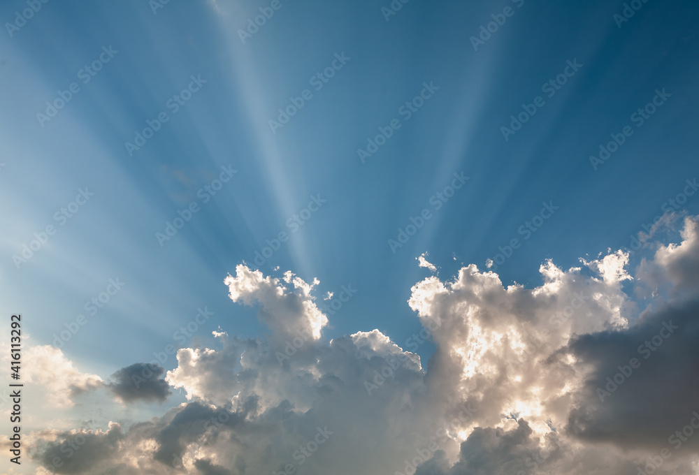 A sky with white clouds and beautiful sunbeams passing through the ...