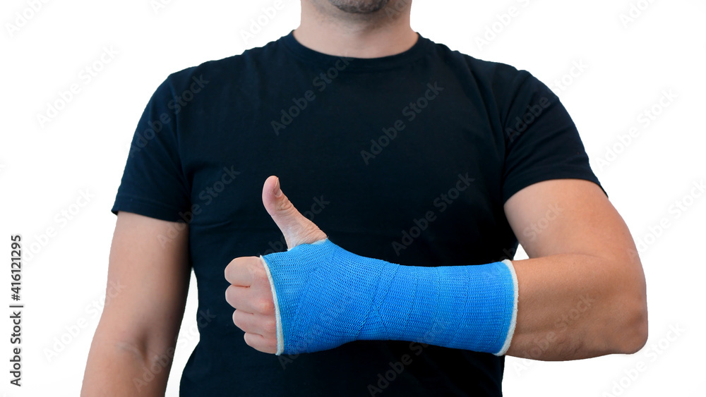 Unrecognizable man in a black T-shirt shows thumbs up and hand wrapped ...