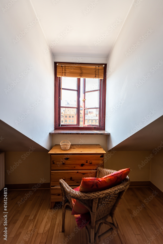 Slanted cathedral ceiling and window in loft vertical view with table ...