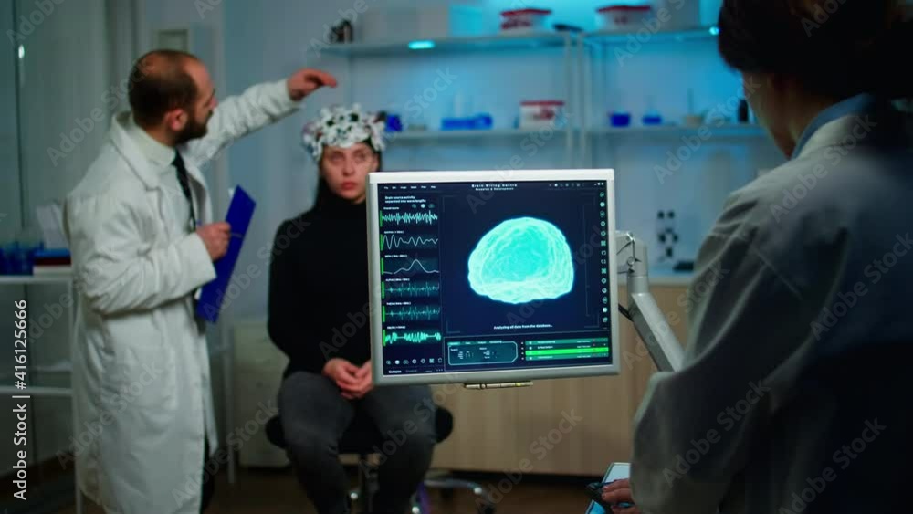 Science doctor looking at computer with medical brain scan film showing ...