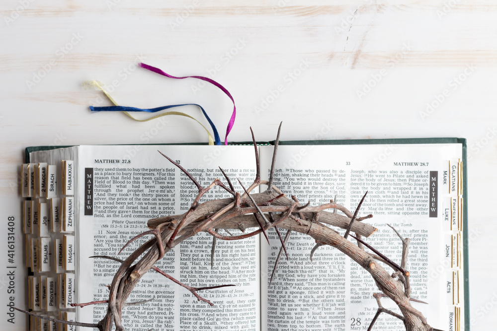 Crown of thorns and open bible on white wood background Stock Photo ...