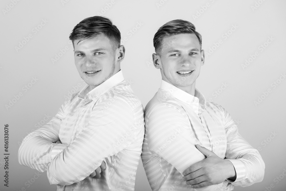 Two brothers smiling. Happy men with hands folded. Models gays standing ...