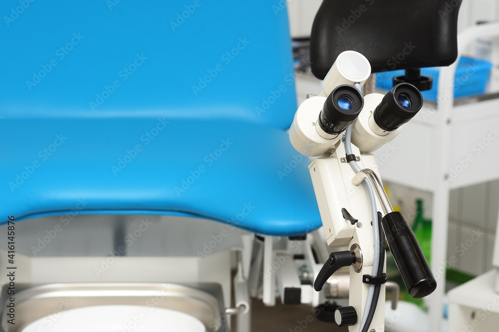 blue gynecological chair and colposcope close-up in a modern clinic ...