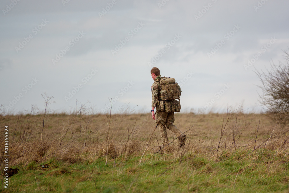 British Army soldier completing an 8 mile tabbing exercise with fully ...