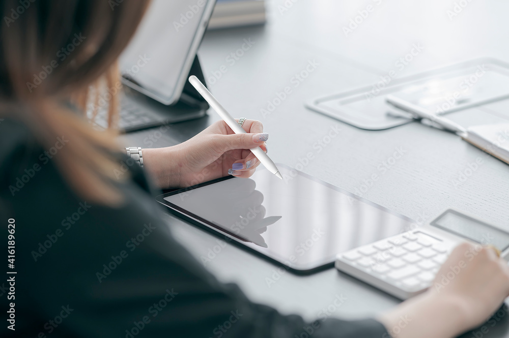 Closeup image of woman hand using stylus pen with tablet while doing ...