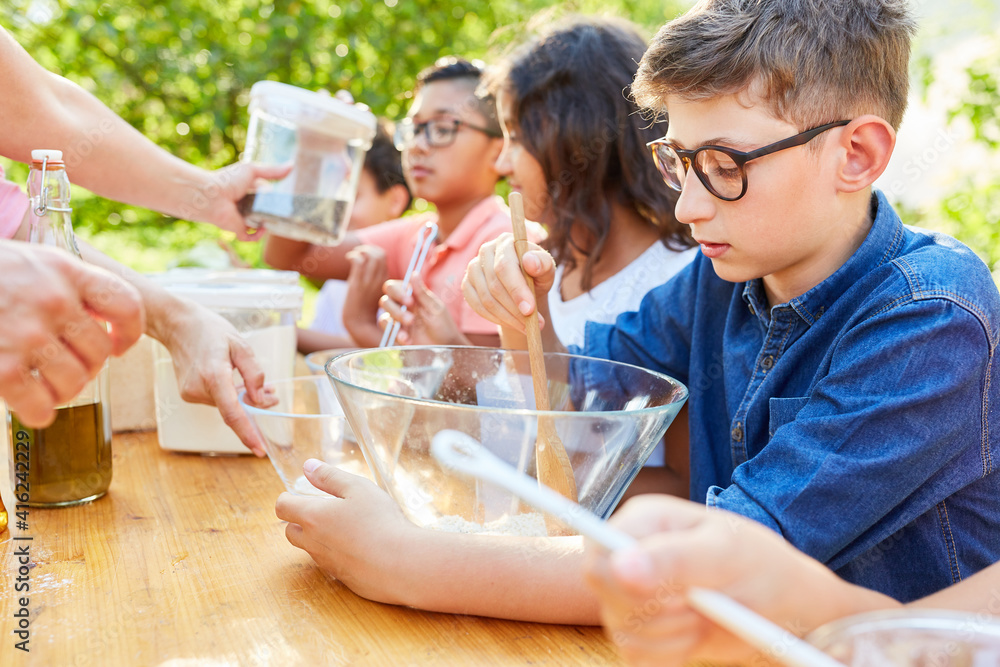 Boy with friends in cooking class at summer camp Stock Photo | Adobe Stock