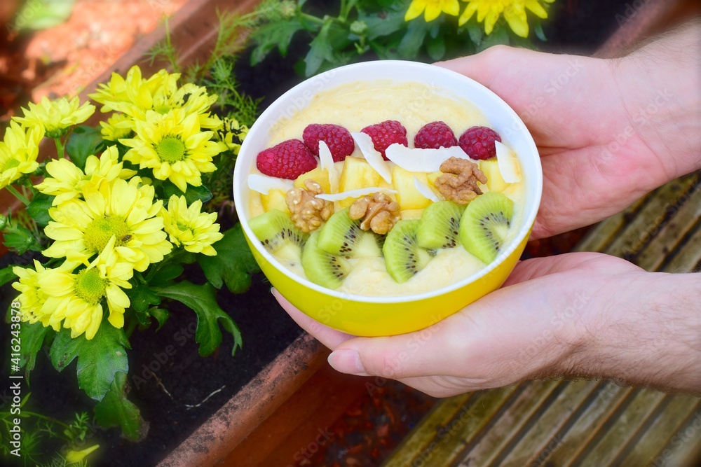 Mango banana pineapple smoothie bowl topped with raspberry, kiwi ...