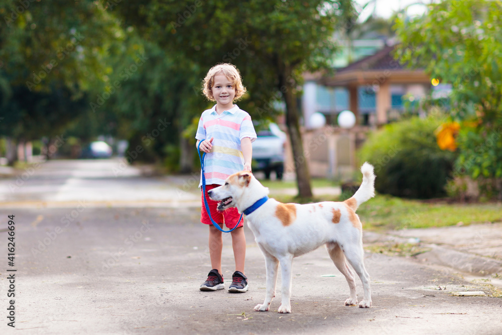 Child walking dog. Kids and puppy. Boy and pet. foto de Stock | Adobe Stock