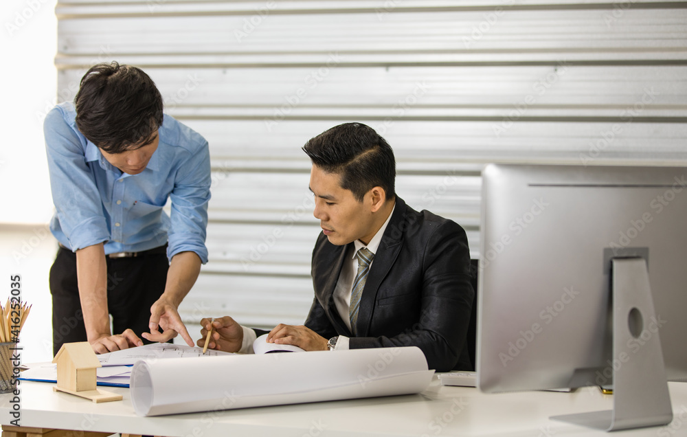 Asian senior good-looking boss in suit sitting at desk and working with ...
