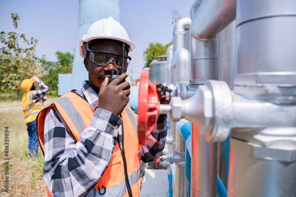 Africa American worker with assistant wearing safety goggles check ...
