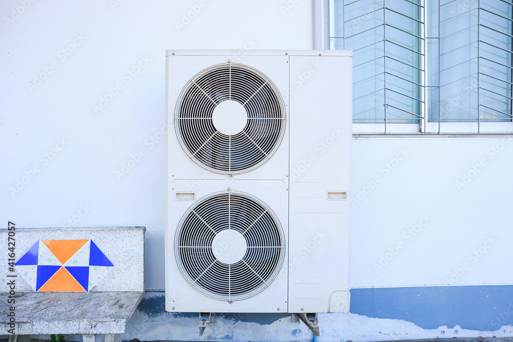 Condenser unit or compressor outside home or residential building. Unit ...