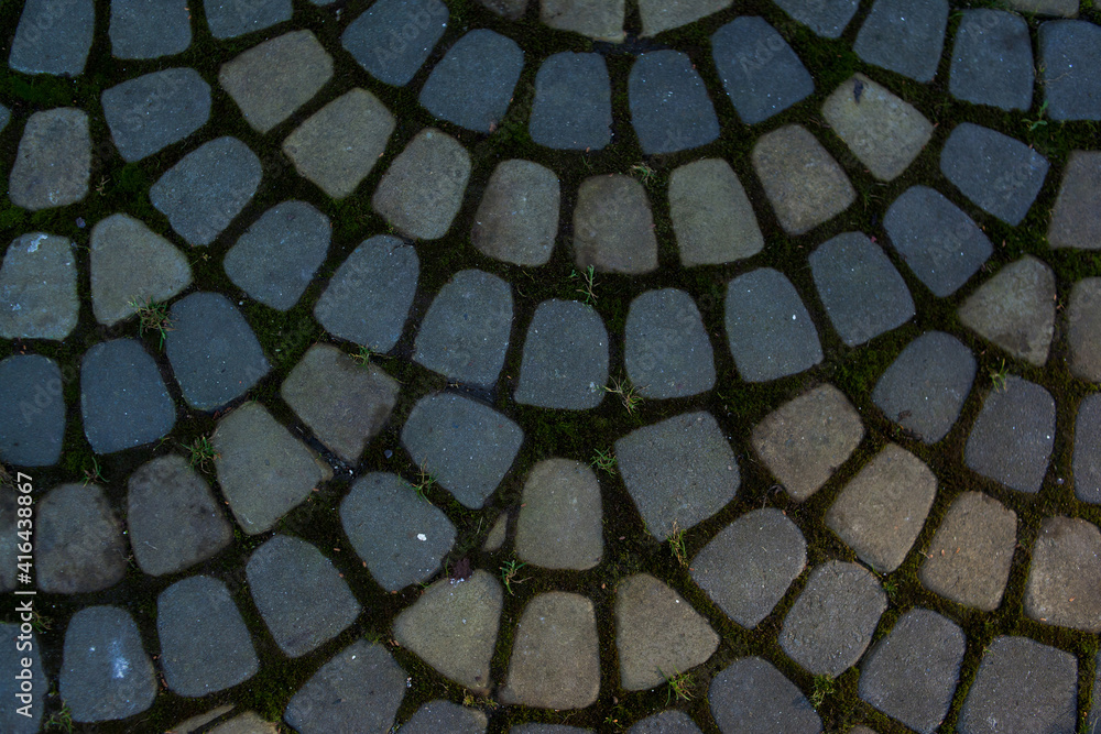 Texture of stone paving stones. Cobblestone arched pavement road at the ...