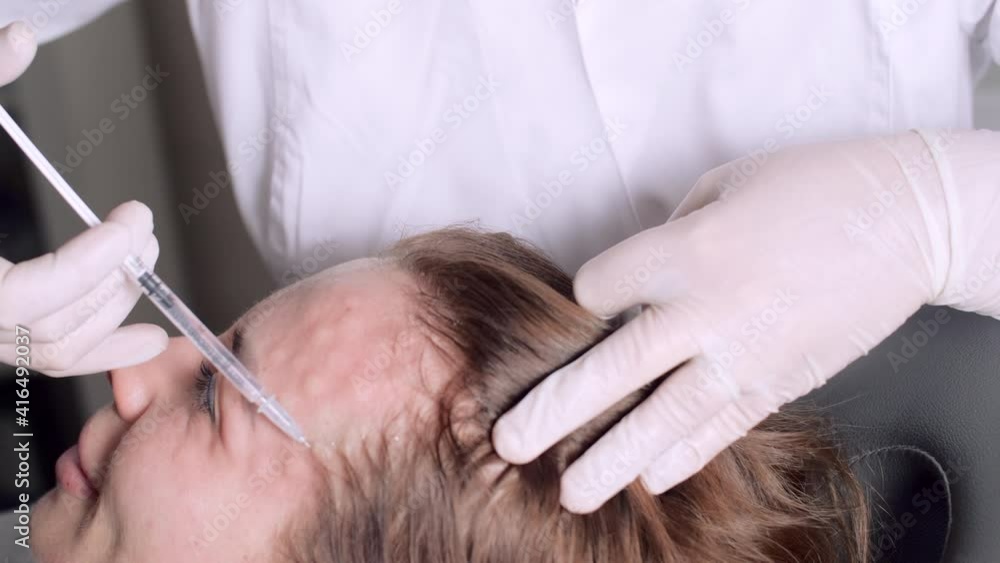 Cosmetological procedure mesotherapy of the head. Doctor's hands in ...
