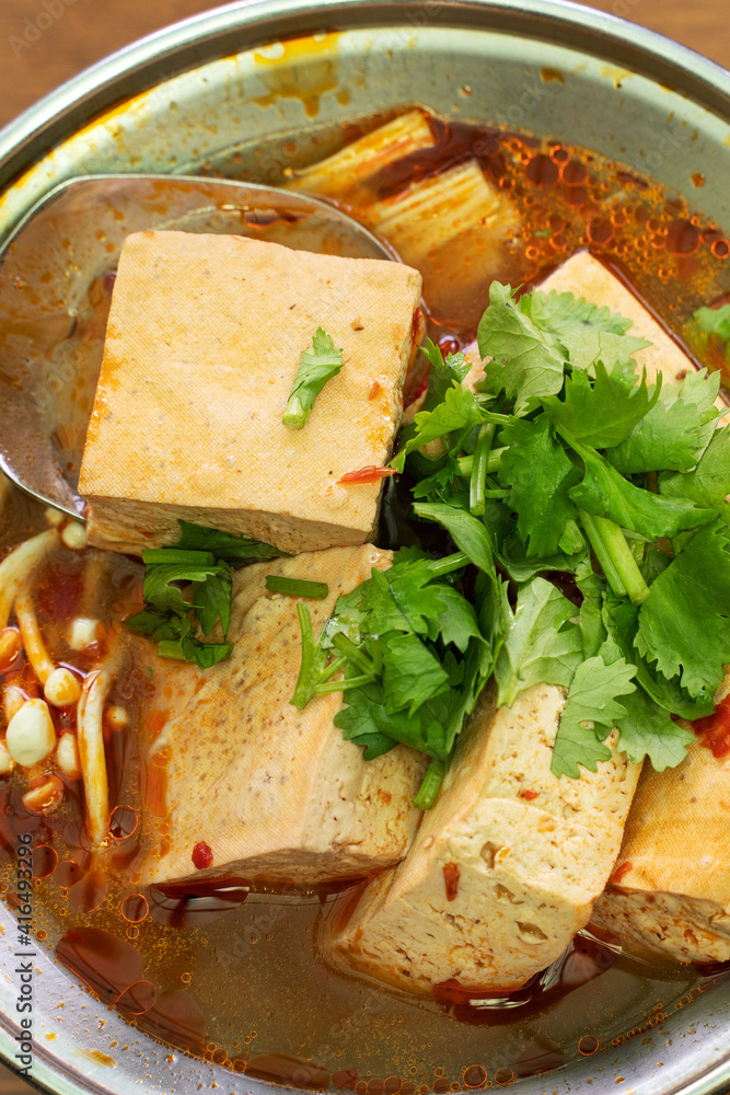 Eating stinky tofu hot pot with spicy soup. Stock Photo | Adobe Stock