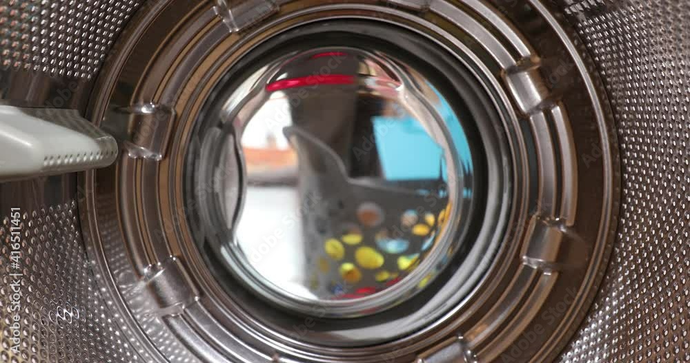 View Looking Out From Inside Washing Machine As boy Puts In Laundry ...
