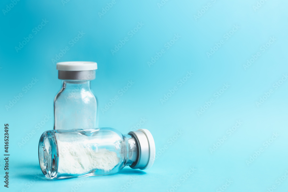 Vials of medicine in powder form on blue background, soft focus Stock ...