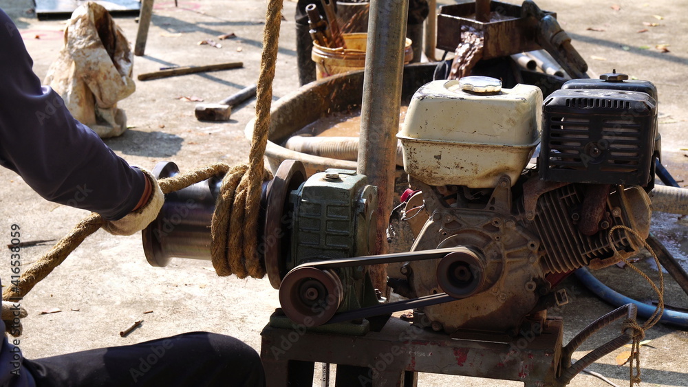 worker was pulling the rope from on pulleys of engine. Stock Photo ...