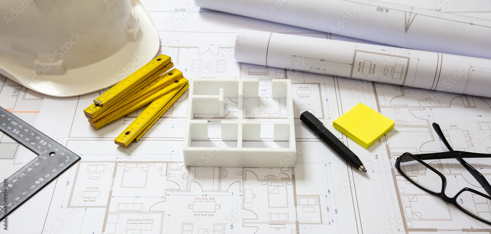 Construction concept. Residential building drawings and hardhat on an ...
