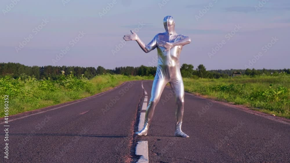 Tall slender man in silver suit is fully dressed in tight silver suit ...