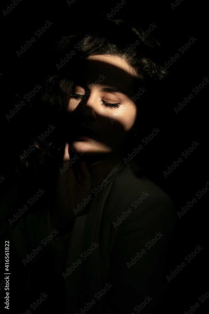 Shadow on the face. Beautiful woman's face in stripes of light.The ...
