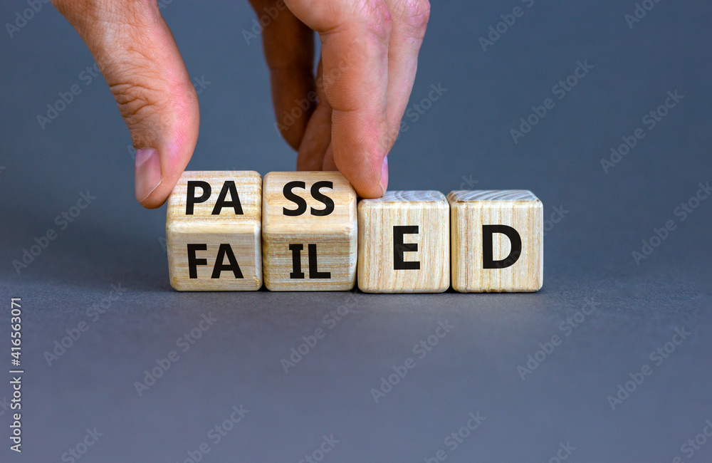 Passed or failed symbol. Businessman turns wooden cubes and changes the ...