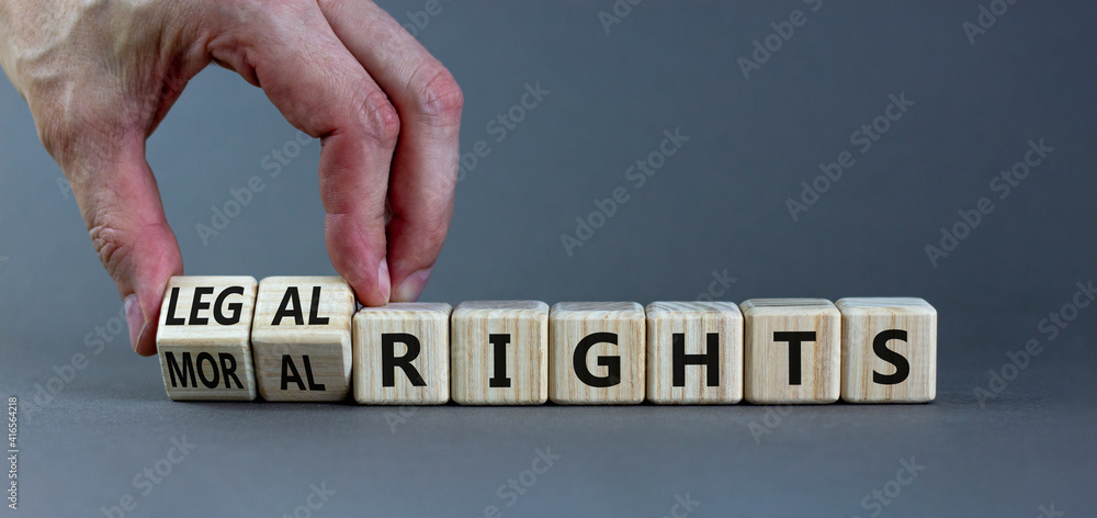 Moral or legal rights symbol. Businessman turns wooden cubes and ...