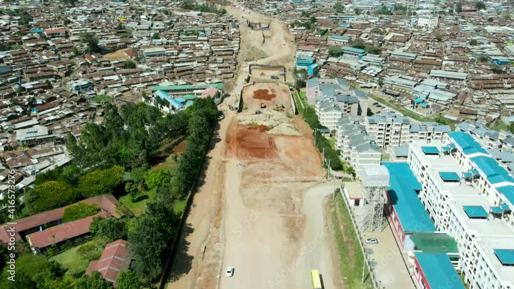 Poor Slums district with old rubble stony road and modern capital city ...