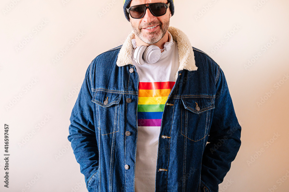 45-year-old man dressed in a white T-shirt with the pride flag, denim ...