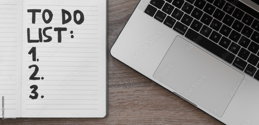 TO DO List, laptop on desk. Wooden table, working from home concept of ...