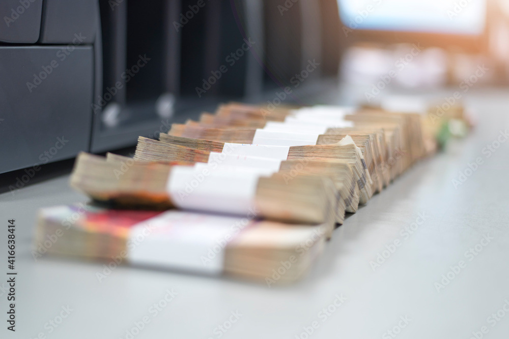 Bundles of banknotes divided into groups with currency straps placed on ...