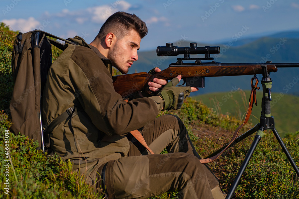 Man on the hunt. Poacher in the Forest. Hunter with shotgun gun after a ...