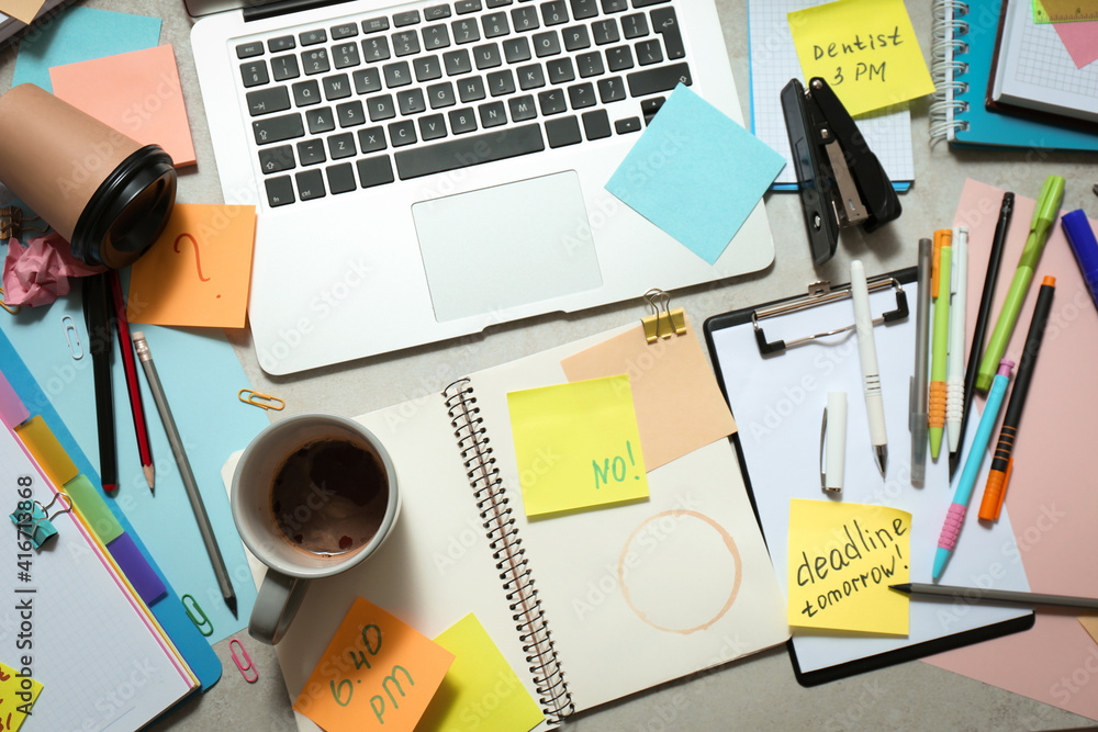 Messy table with laptop and coffee, flat lay. Concept of being ...