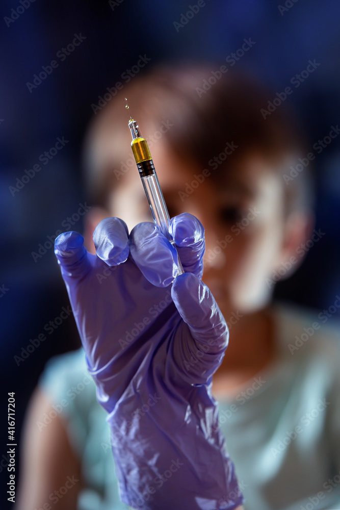 Pediatrician Nurse with an injection in the hand for the vaccination of ...
