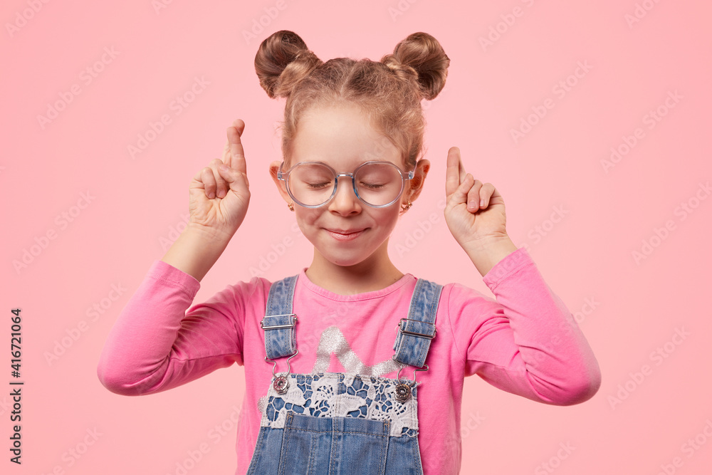 Little girl with crossed fingers making wish Stock Photo | Adobe Stock