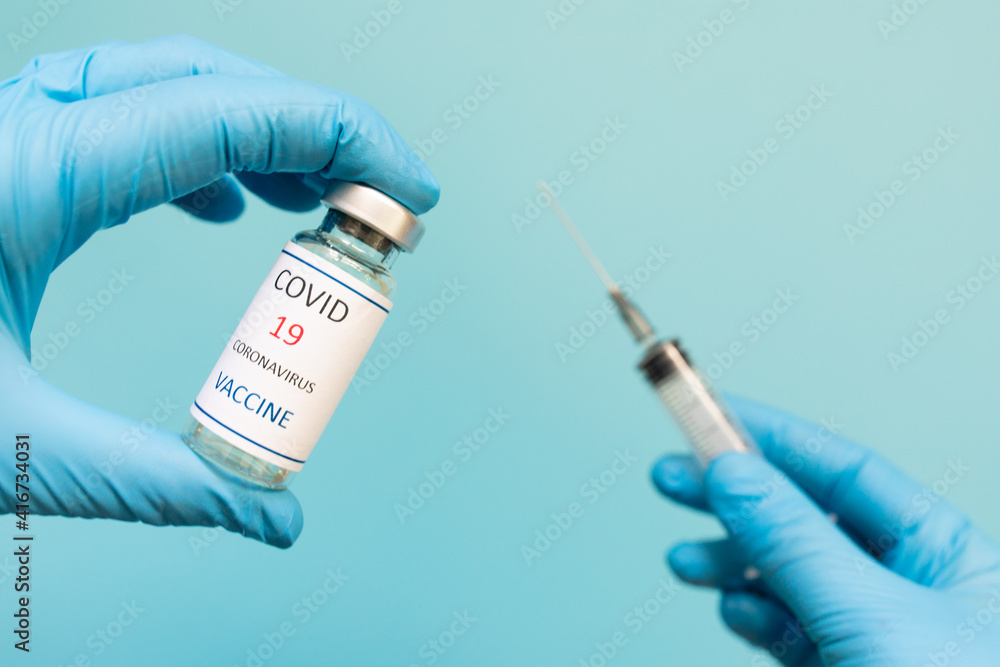 Doctor is holding a vaccination record card and corona virus vaccine ...