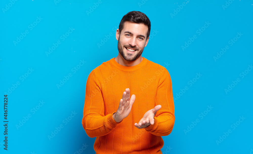 handsome adult blond man feeling happy and successful, smiling and ...