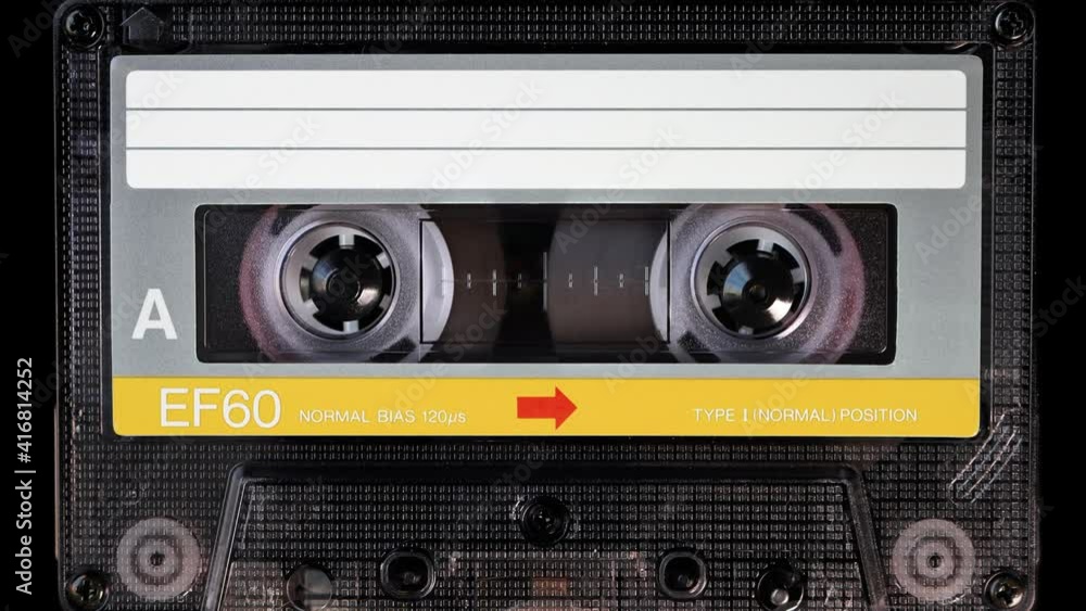 Audio cassette tape in use for sound recording in the tape recorder. A ...