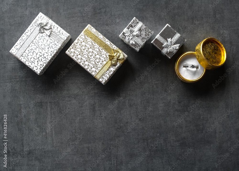 Silver and gold shining gift boxes with diamond one stone golden ring ...