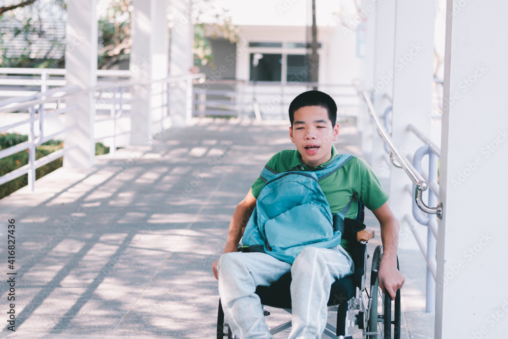 Asian special child on wheelchair is smiling face as happiness on ramp ...
