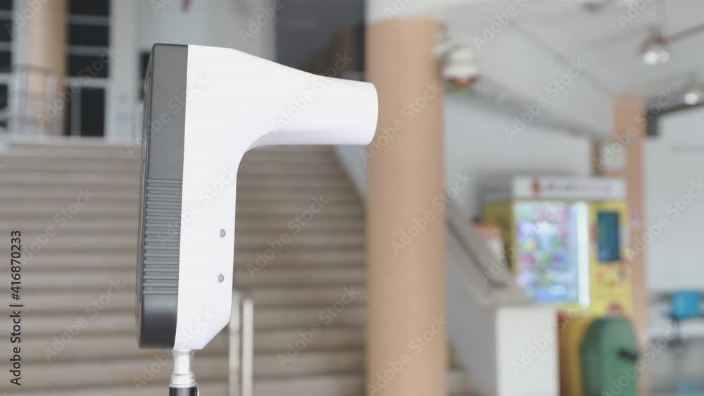 Man approached the forehead thermometer sensor to detect body heat ...