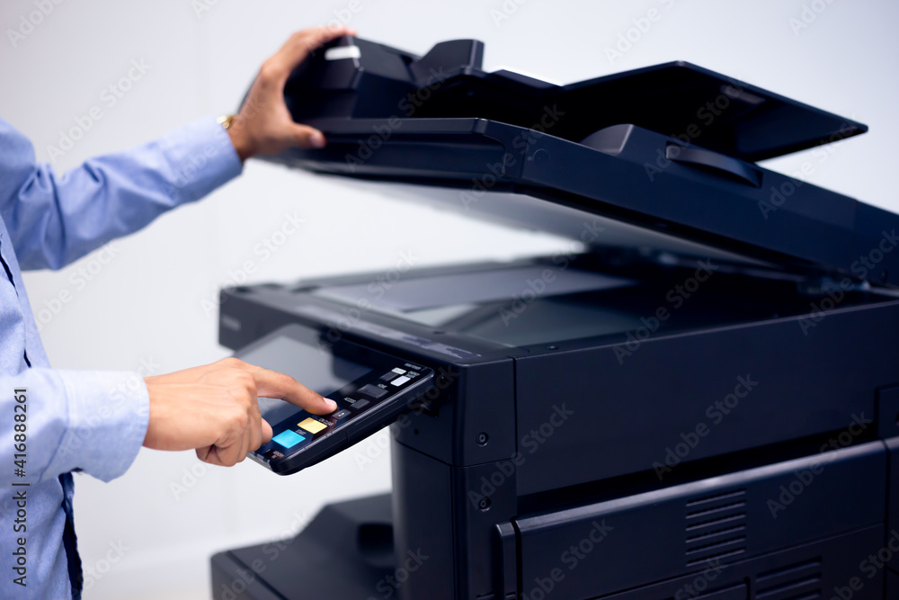 Bussiness man Hand press button on panel of printer, printer scanner ...