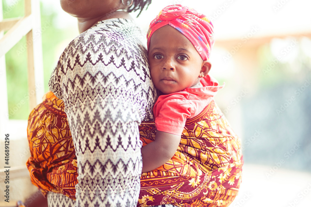 selective focus of beautiful african baby at her mother's back Stock ...