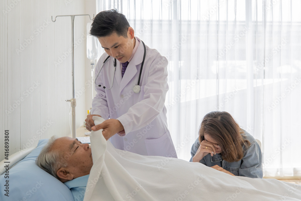 A young asian male doctor wearing white lab coat and stethoscope ...