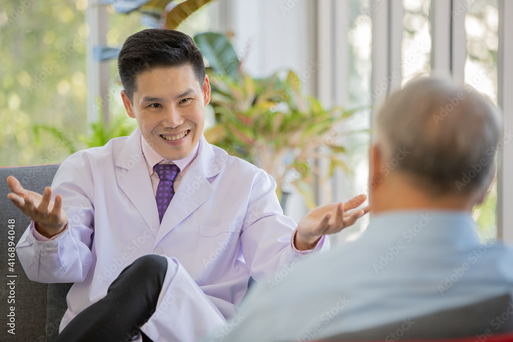 A young handsome male asian doctor wearing white lab coat with ...