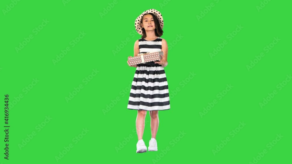 Beautiful little girl a gift box walking on a Green Screen, Chroma Key ...