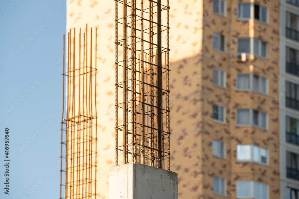 armature in a concrete column against residential building at ...