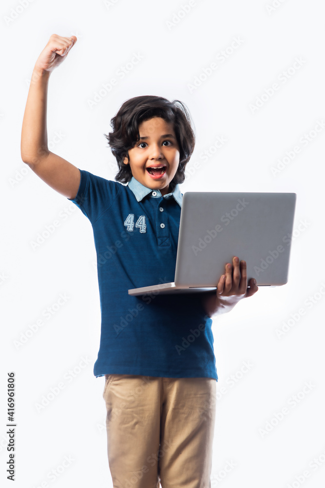 Indian cute little boy working on laptop while standing isolated Stock ...